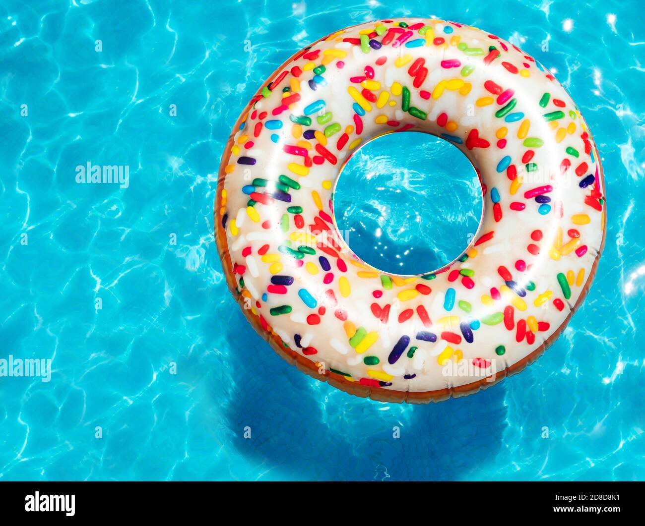 Inflatable candy doughnut buoy swim in the swimming pool view from ...