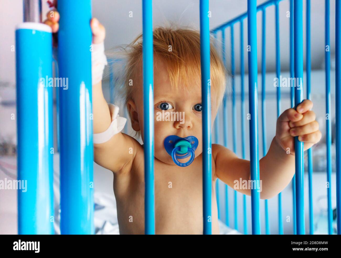 Close photo portrait of a little toddler stand in hospital bed with ...