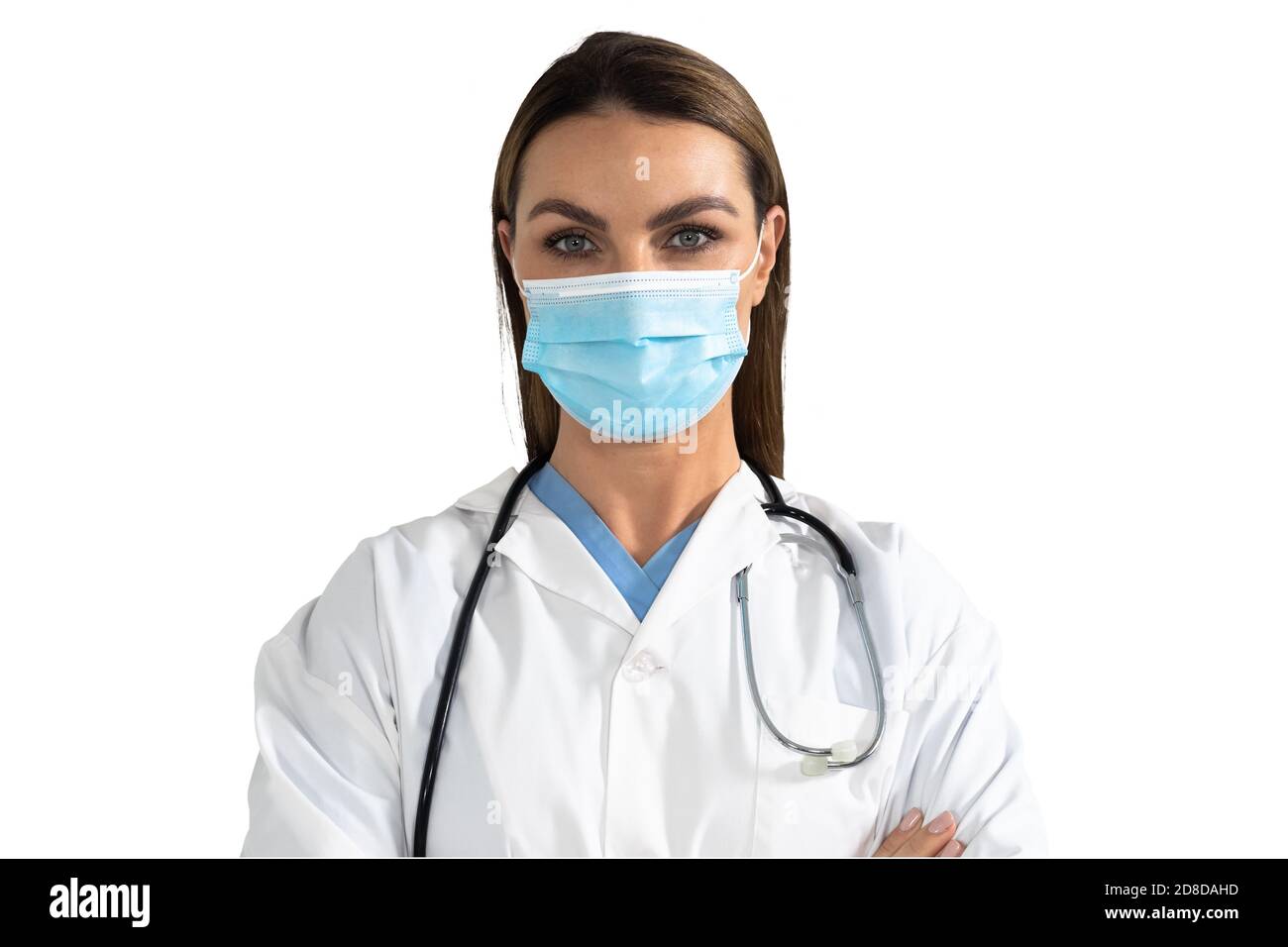 Portrait of female doctor wearing face mask against white background ...