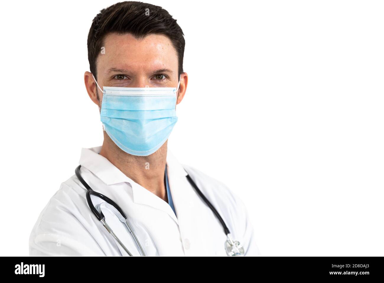 Portrait of male doctor wearing face mask against white background ...