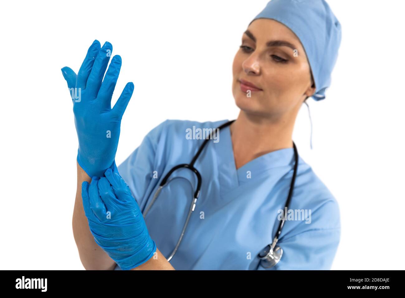 Female surgeon wearing protective gloves against white background Stock ...