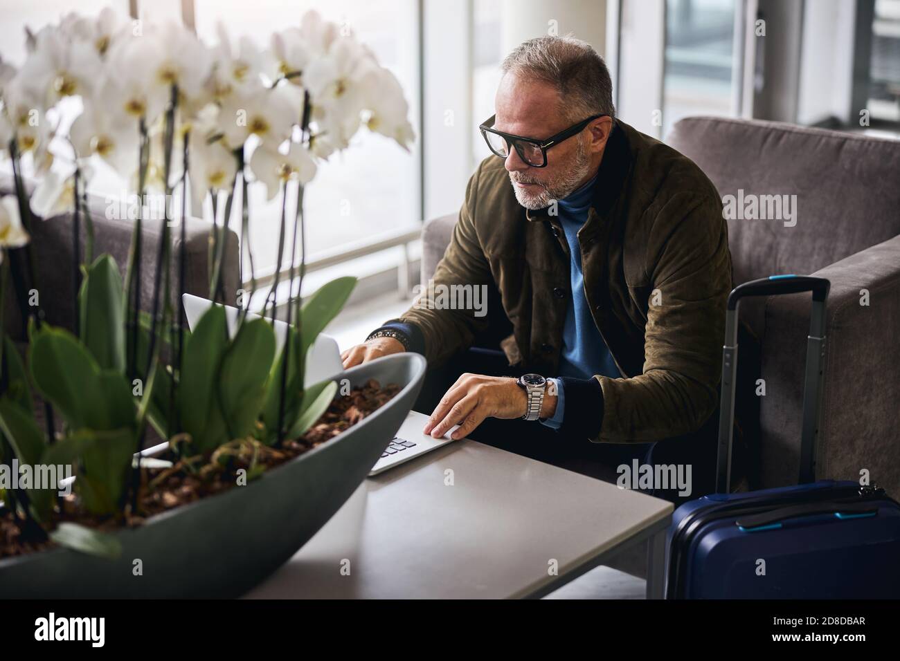 Gray-haired man staring at his laptop screen Stock Photo - Alamy