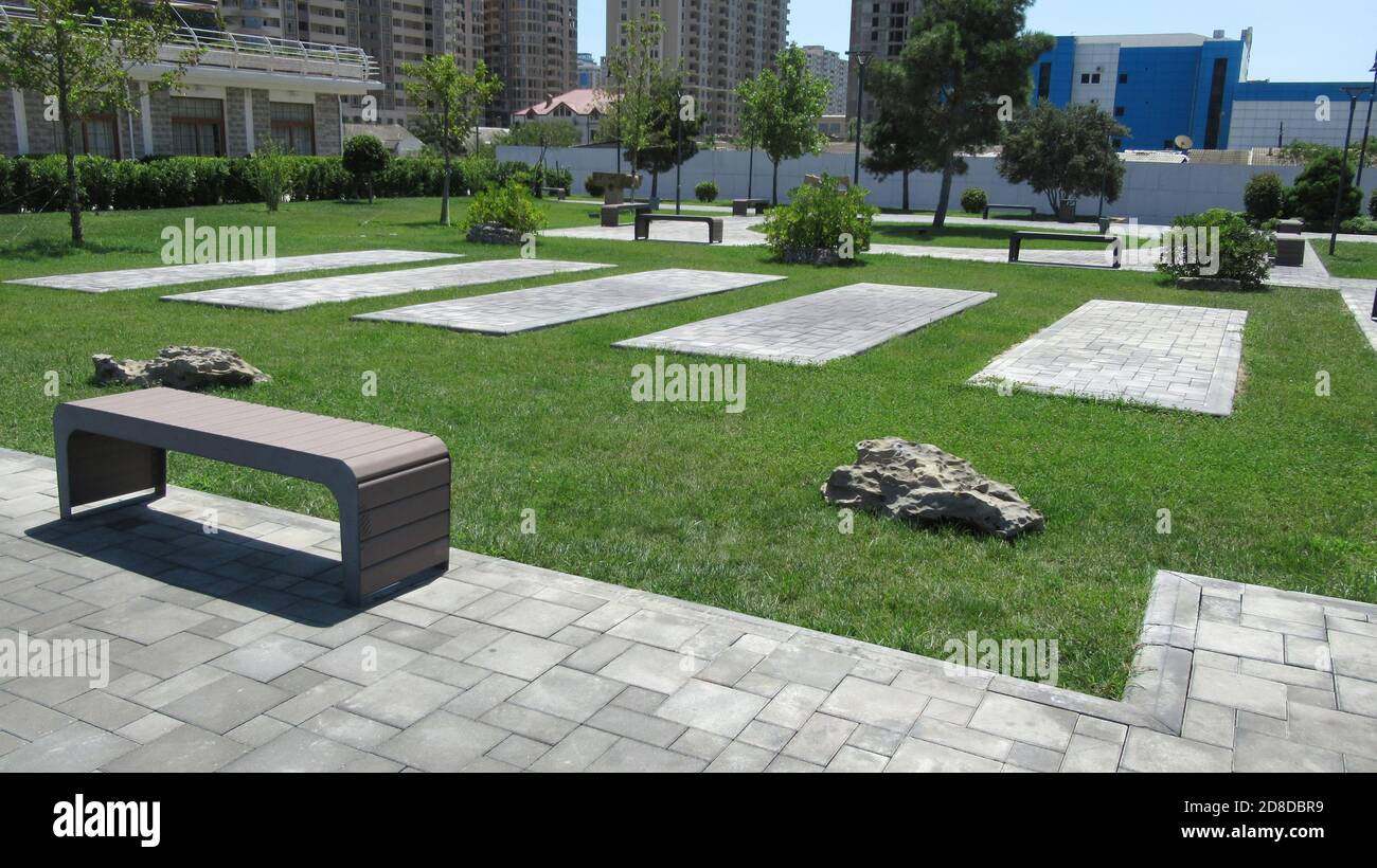 Rectangular shaped pavement stones in the middle of a grass Stock Photo ...