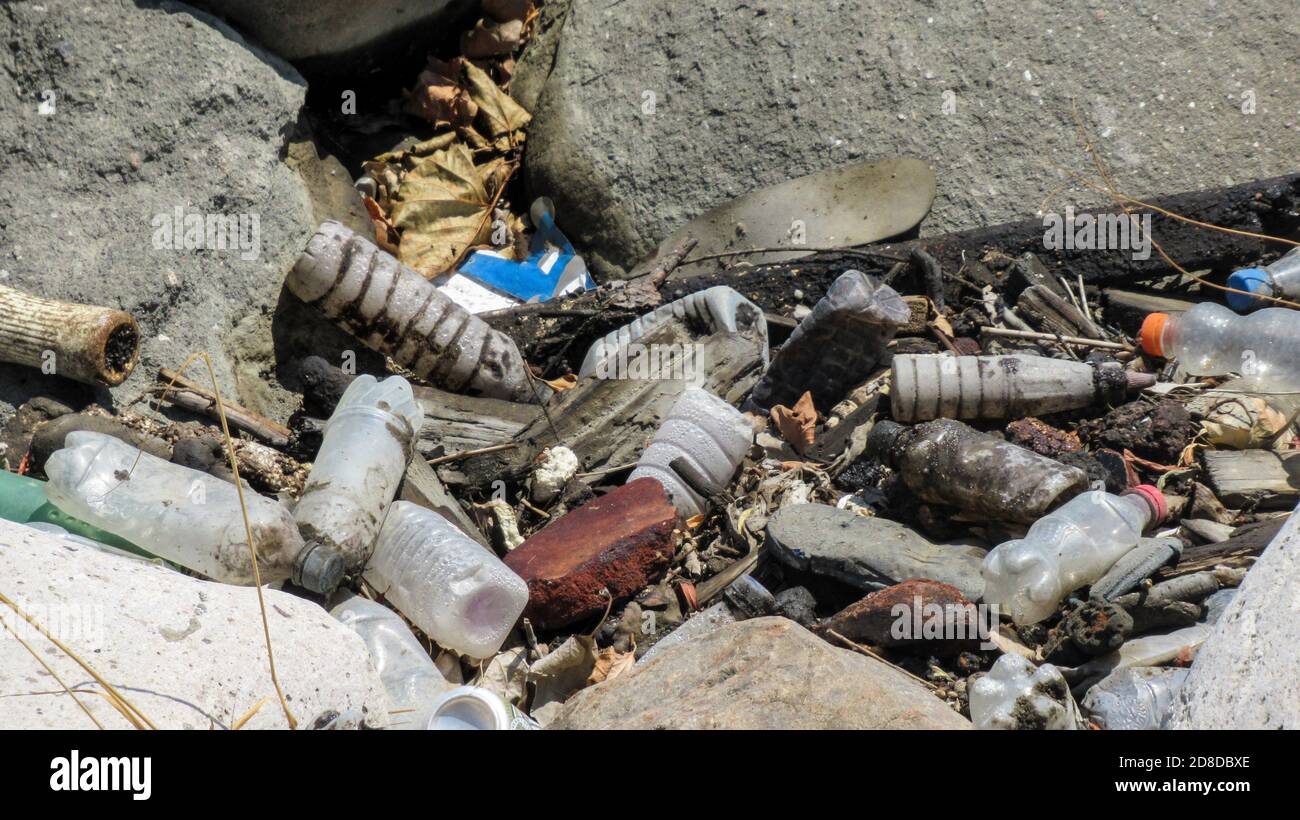 Plastic waste. Ecological dirt spilled garbage on the ground of the big ...