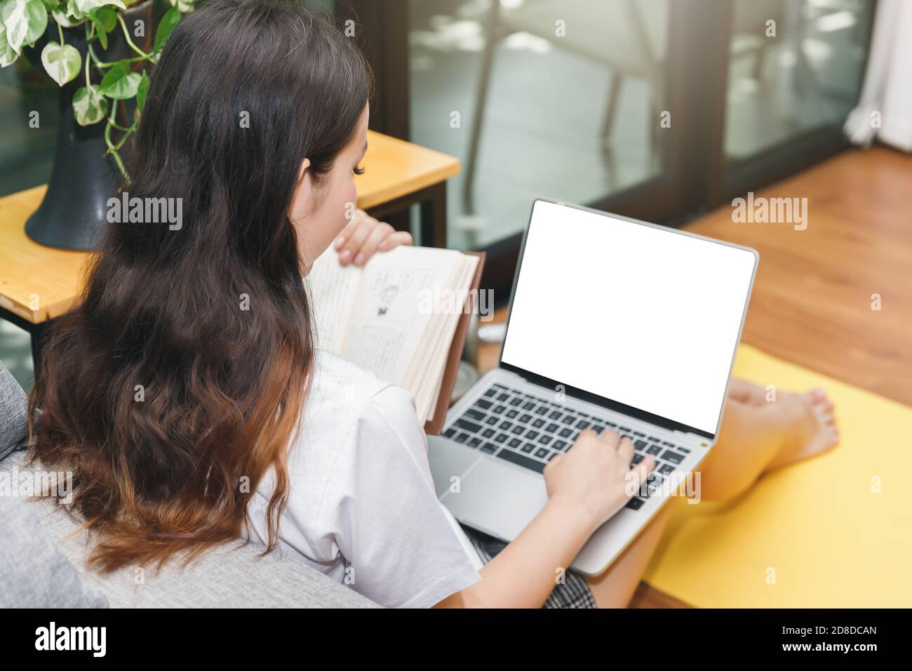 Young student watching lesson online and studying from home. She using ...