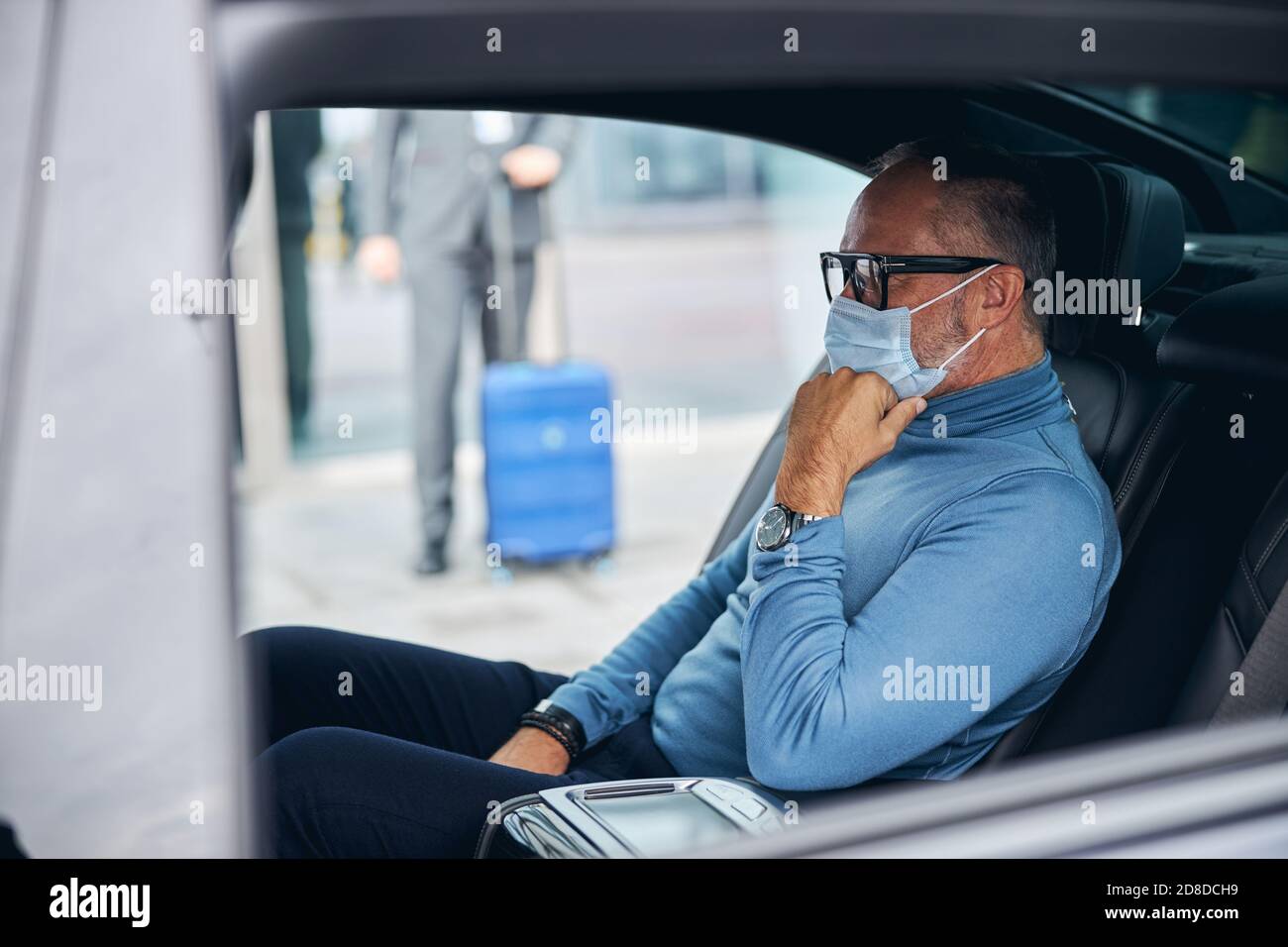 Pensive male passenger waiting for his driver Stock Photo - Alamy