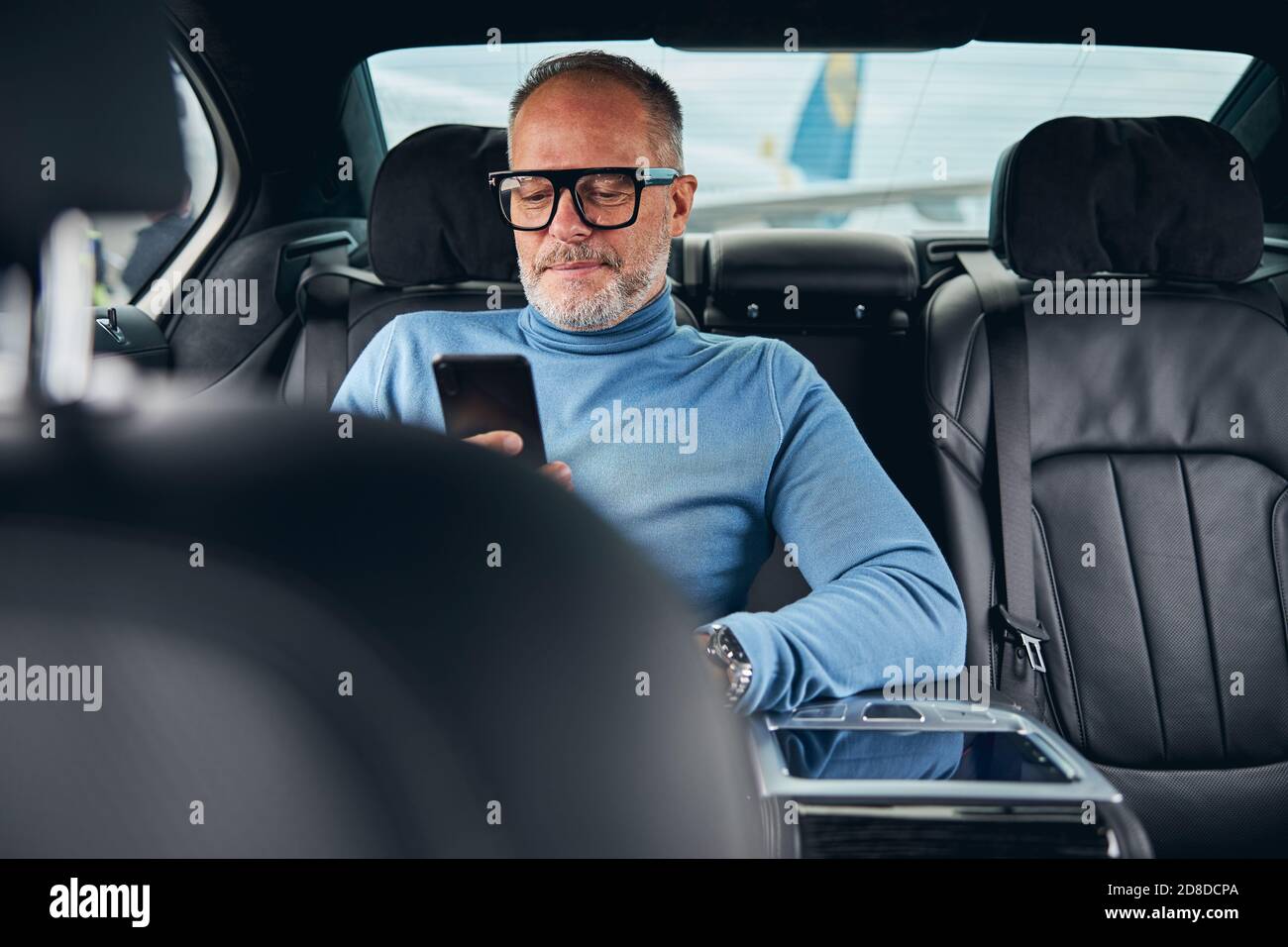 Taxi passenger sitting in the back seat Stock Photo - Alamy