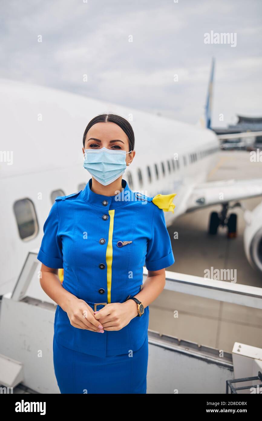 Young female flight attendant staring in front of her Stock Photo - Alamy
