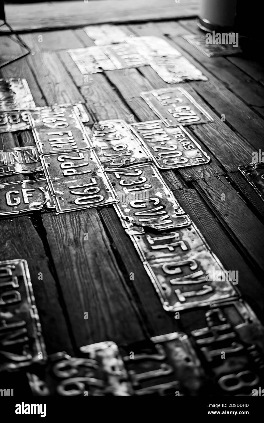 Worn license plates on the floor of a building Stock Photo - Alamy