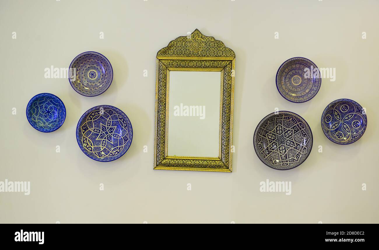 Moroccan antiques. Traditional Moroccan plates and a mirror hanging on ...