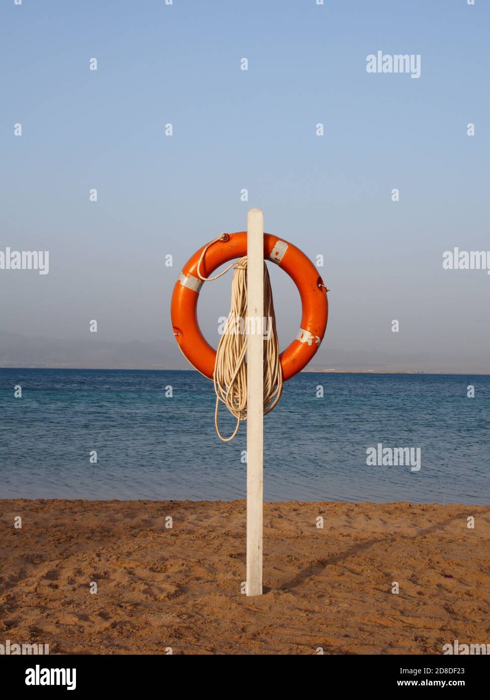 Life buoy ring on the sand beach at sunrise Stock Photo - Alamy