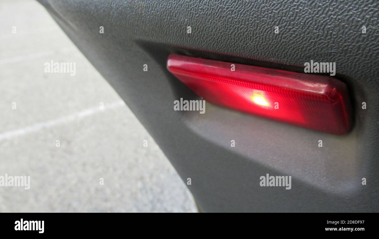 Red stop, warning light inside of a car door Stock Photo - Alamy