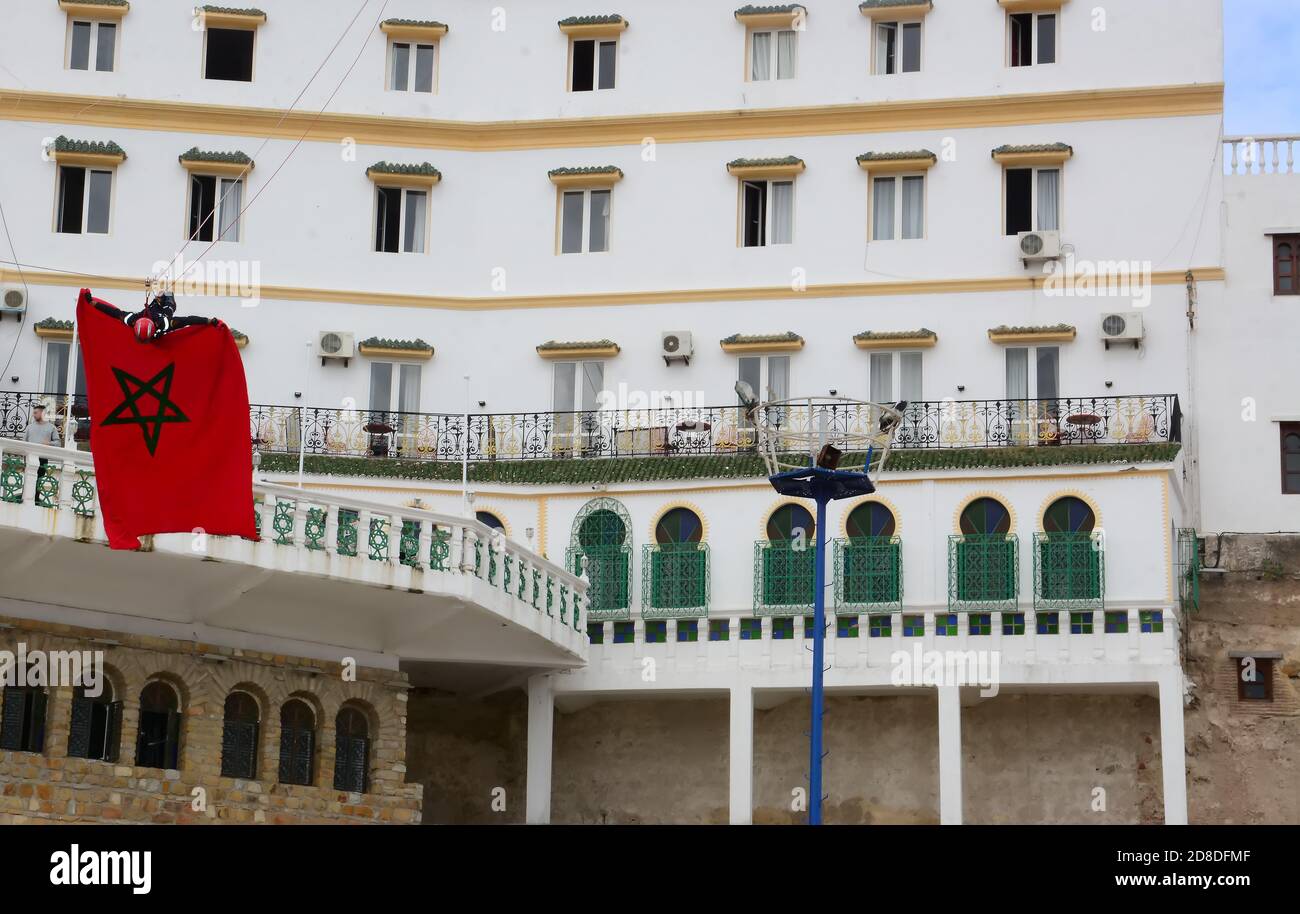 Moroccan firefighter carrying the flag of Morocco Stock Photo - Alamy