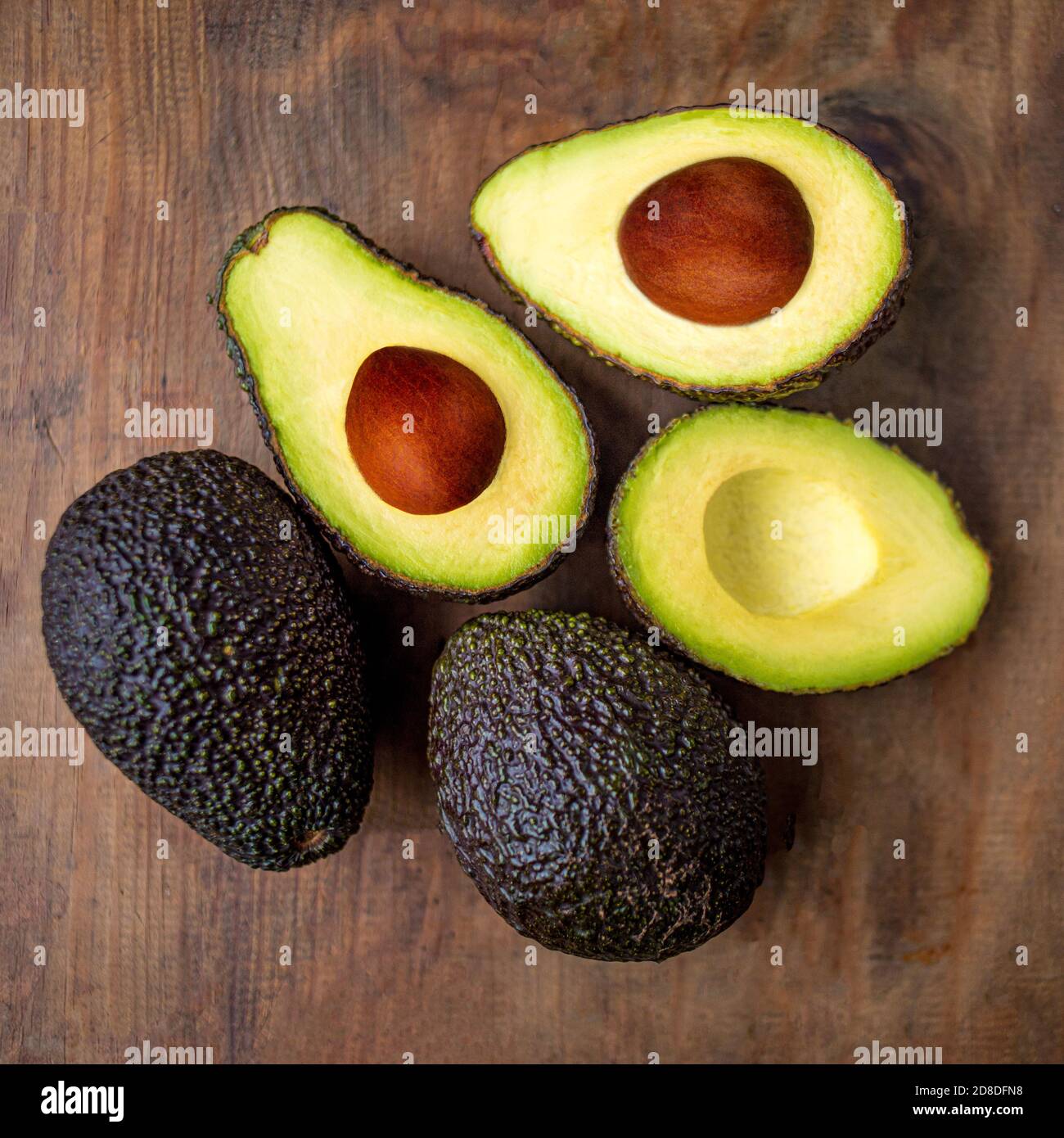 Food background with fresh organic avocado over wooden table, top view ...