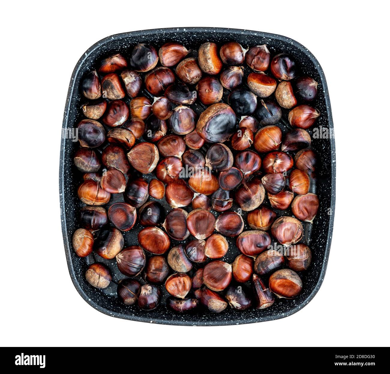 Roasted chestnuts in a black chestnut pan isolated on white background ...