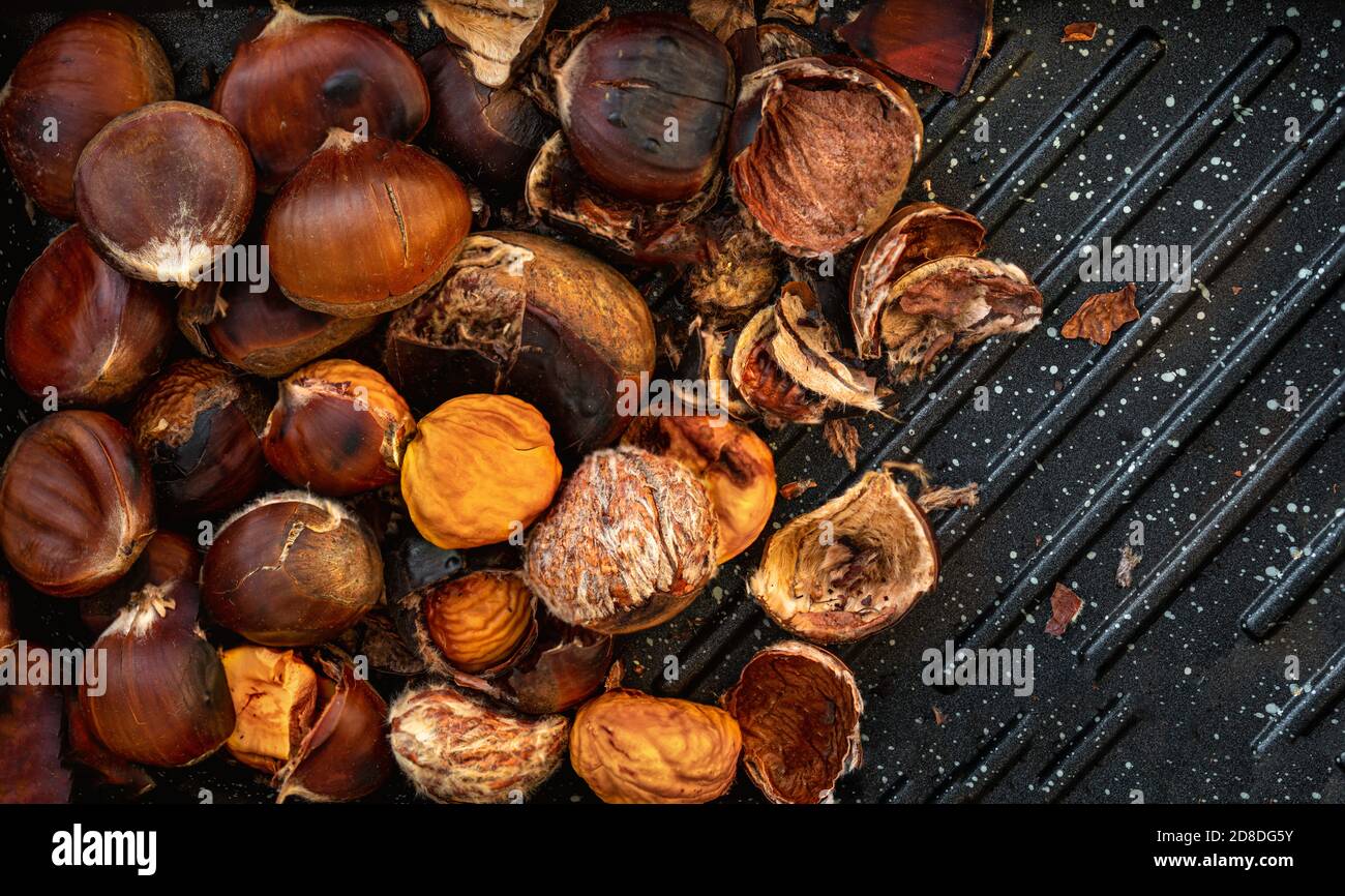 Roasted chestnuts on a black concrete Background. Chestnuts for ...