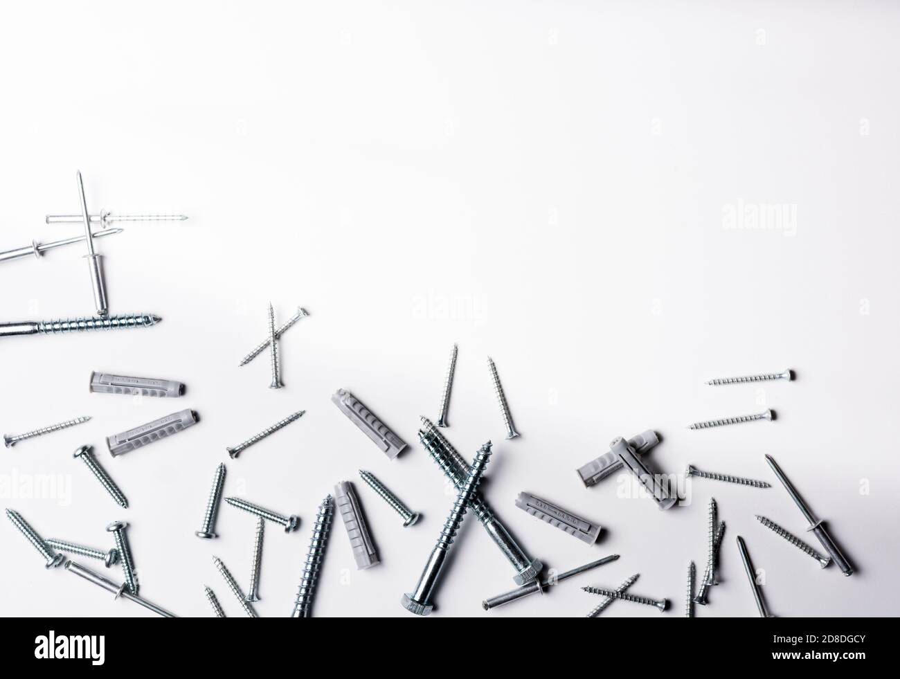Screws and plugs of different kinds on a white background with copy ...