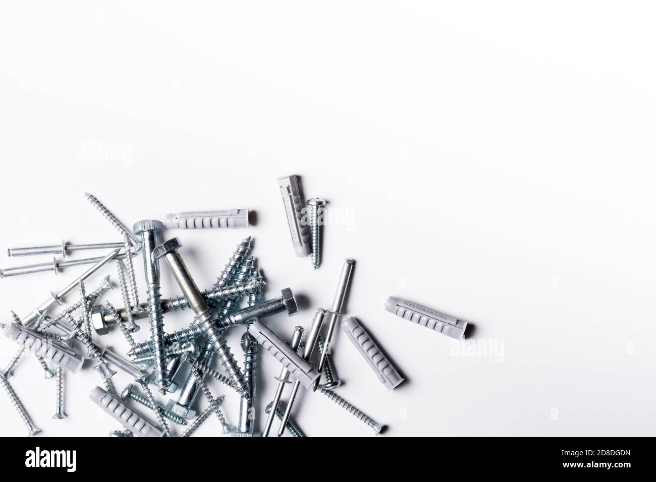 Screws and plugs of different kinds on a white background with copy ...