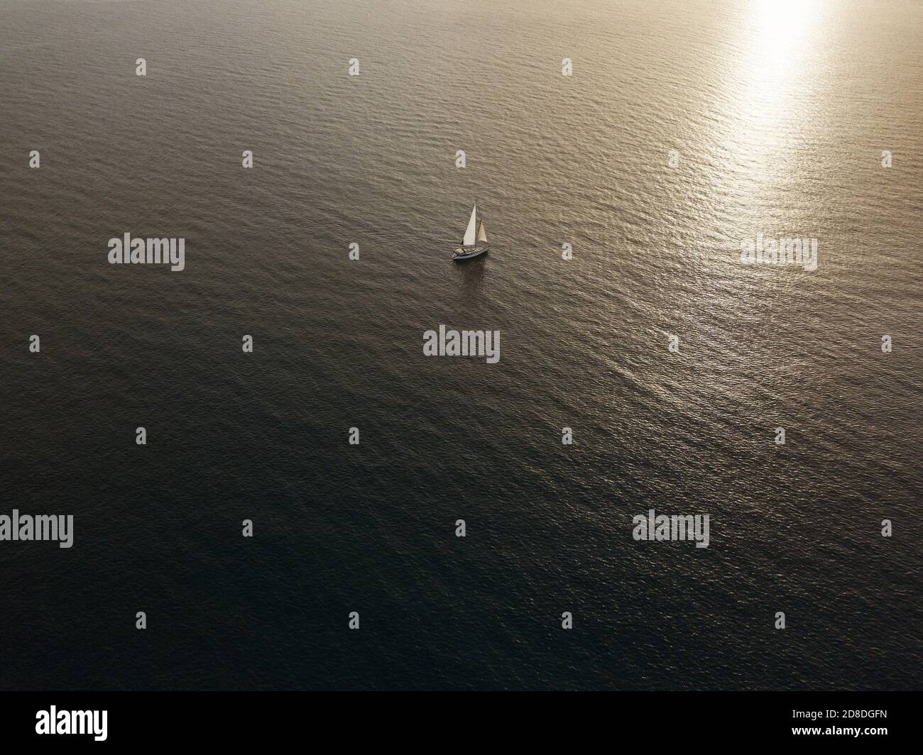 Aerial view of a sailboat sailing in the ocean. Set sail and travel in ...