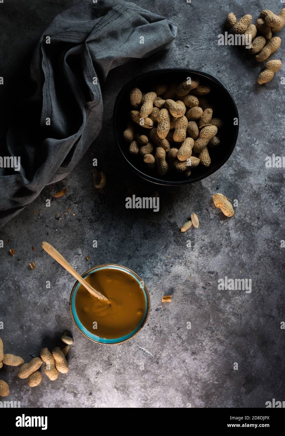 Aerial view photograph of homemade peanut butter in a blue bowl and one ...
