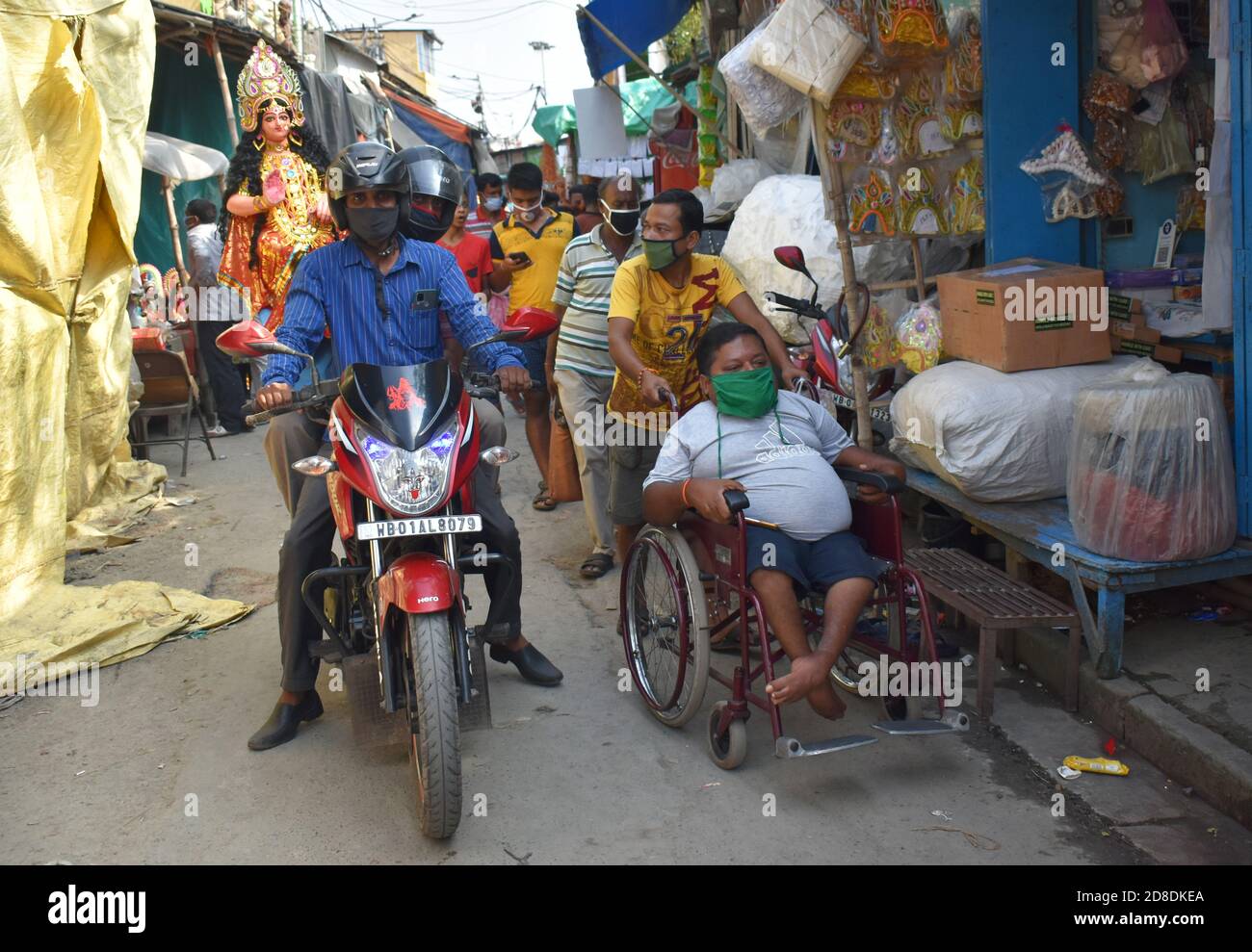 A person carrying a Laxmi idol in his Motorcycle for the occasion of ...
