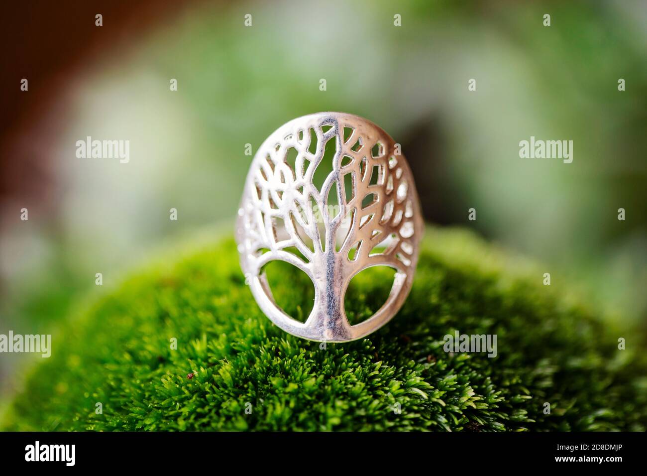 Sterling silver ring in the shape of tree in mandala on green moss ...