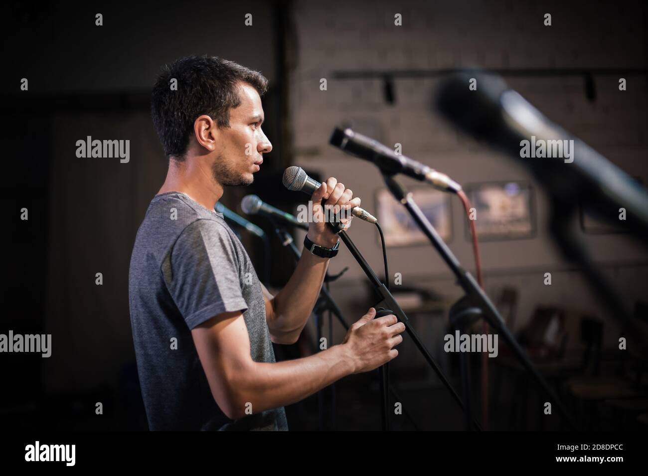 Theater audio technician adjusting an microphones on the scene ...