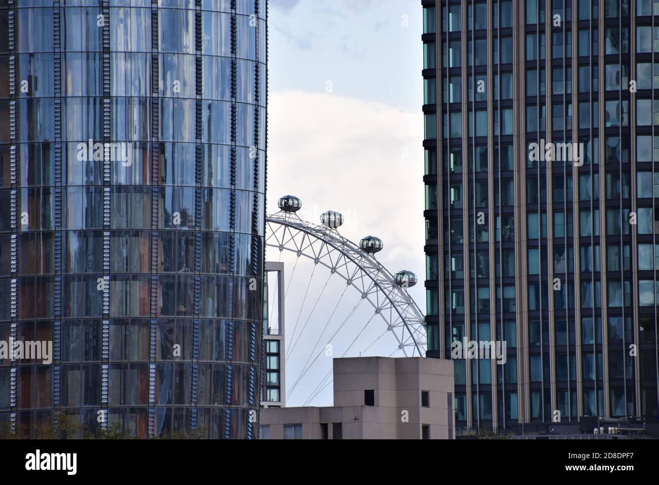 Detail of London Eye seen between two buildings Stock Photo - Alamy