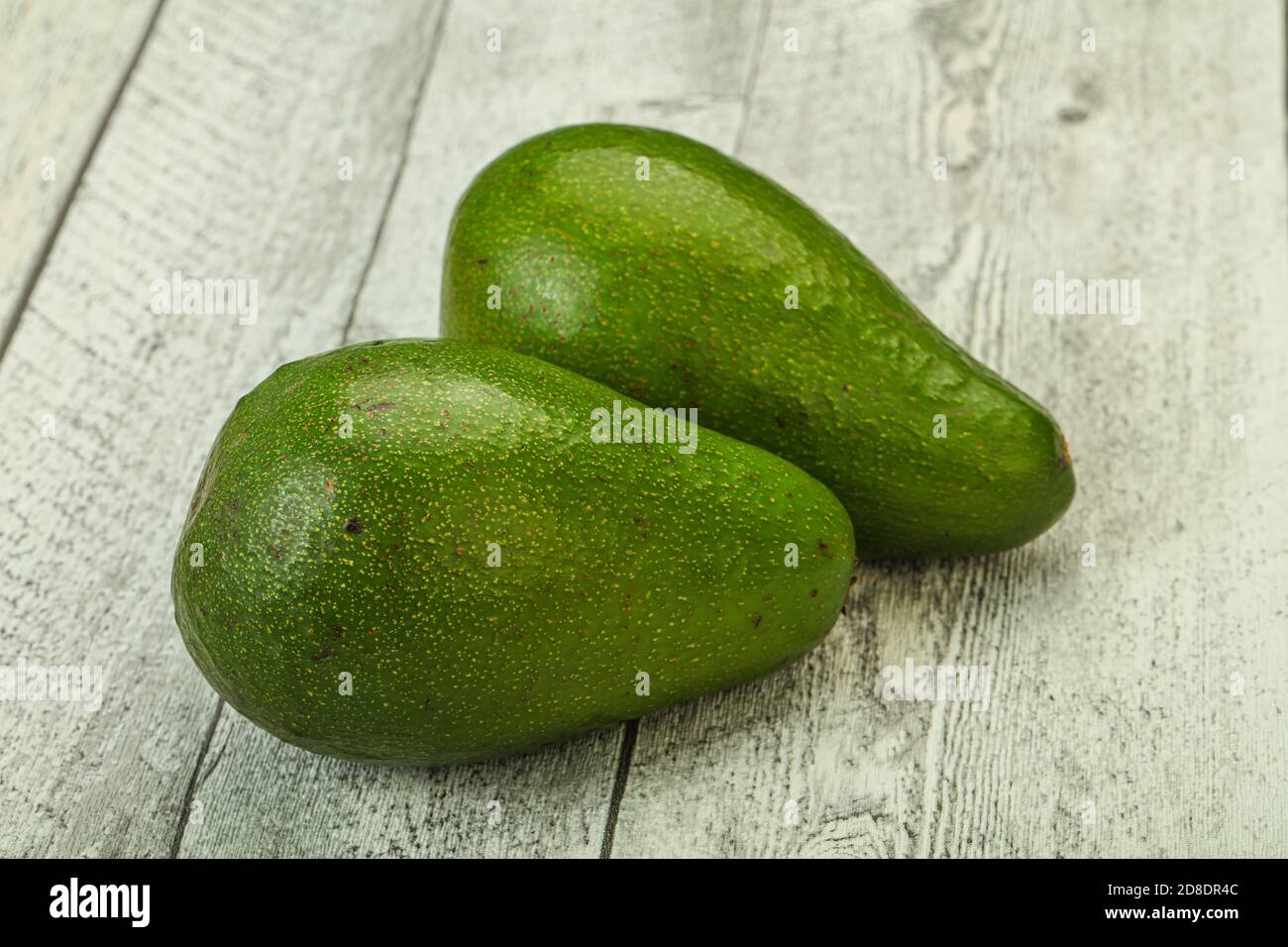 Two ripe exotic green avocado vegetable Stock Photo - Alamy