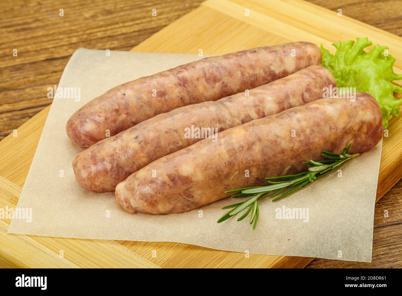 Raw pork meat sausages for grill served rosemary Stock Photo - Alamy