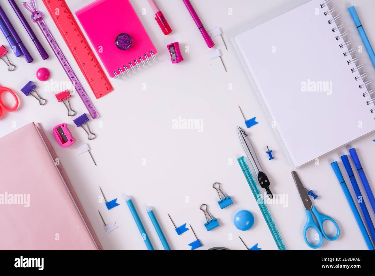 Pink notepad, pencil and marker on pink and blue background. Flat lay ...