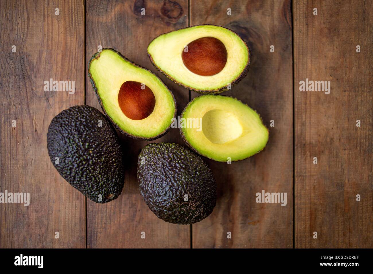 Food background with fresh organic avocado over wooden table, top view ...