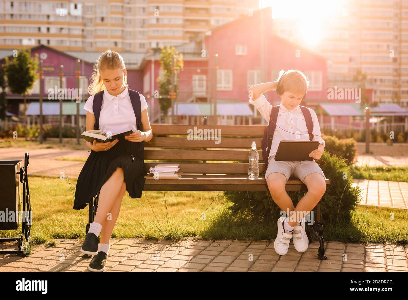 New normal: School boy and girl in the protected masks communicating ...