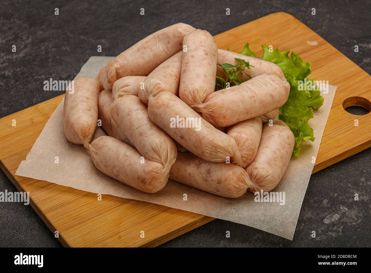 Raw natural chicken baby sausages for roast Stock Photo - Alamy