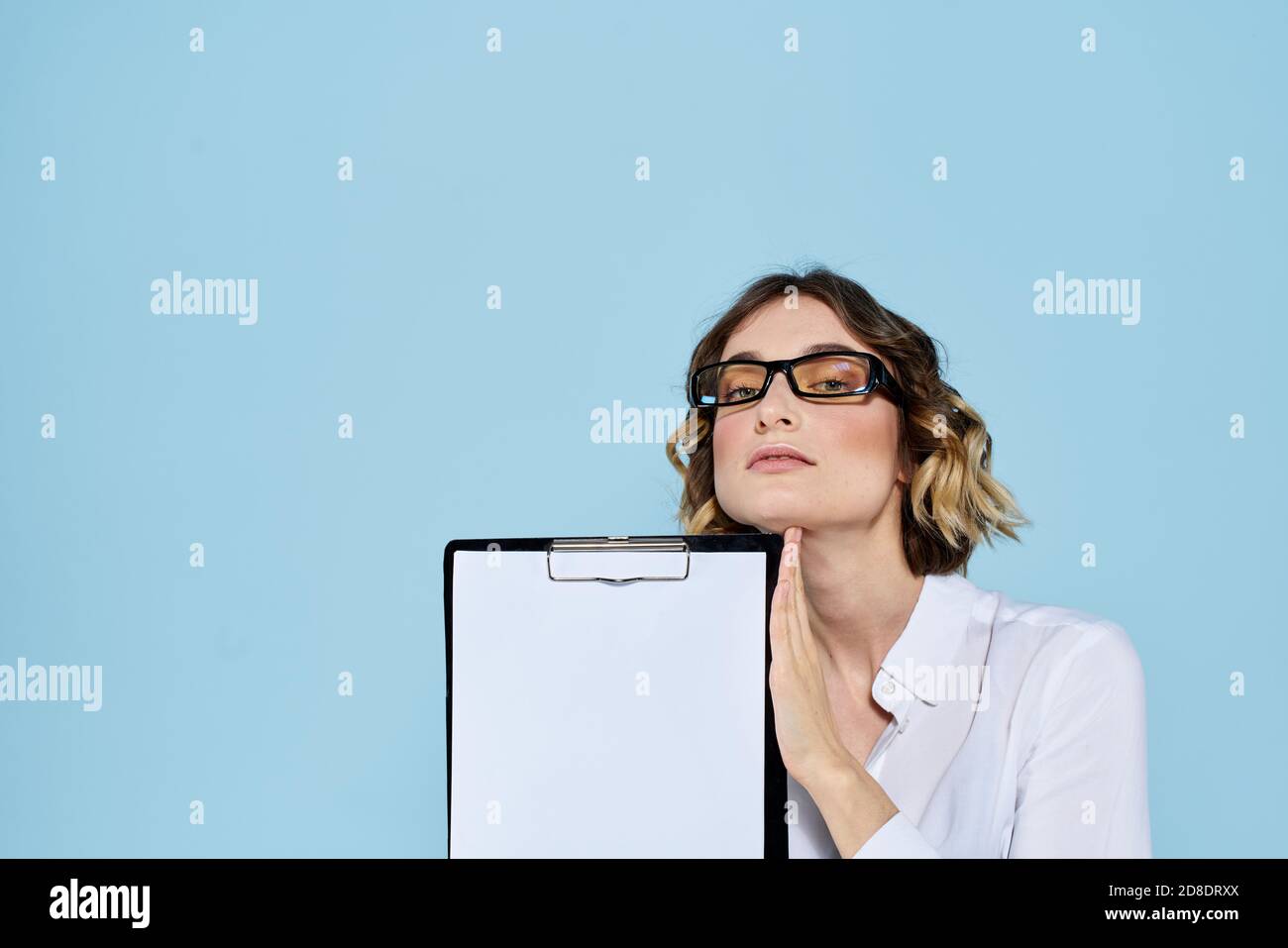 Business woman with documents in a folder on a blue background and in a ...