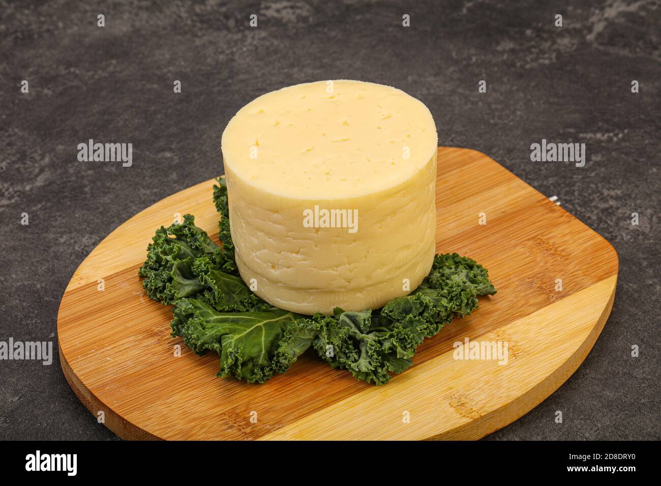 Yellow round dairy soft cheese piece Stock Photo - Alamy