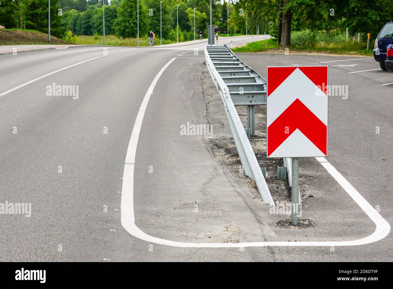 a metal safety barrier with a red and white striped traffic sign at the ...