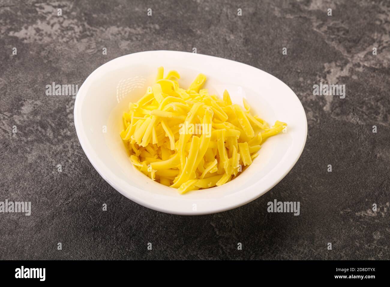 Shredded yellow cheese in the bowl for cooking Stock Photo - Alamy