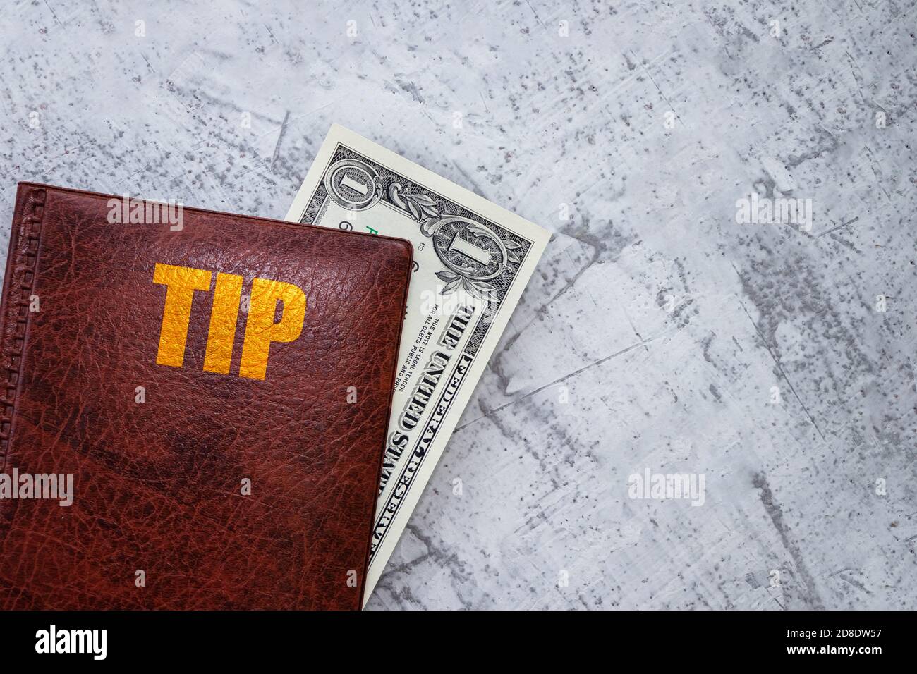 Dollar bill lying in the cover with the inscription: Tip. One dollar in ...