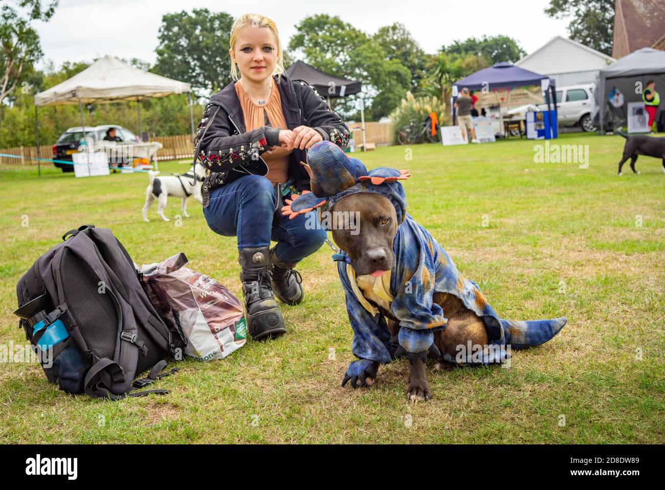 Young female dog owner in Goth clothing with her dog in Climping, West ...