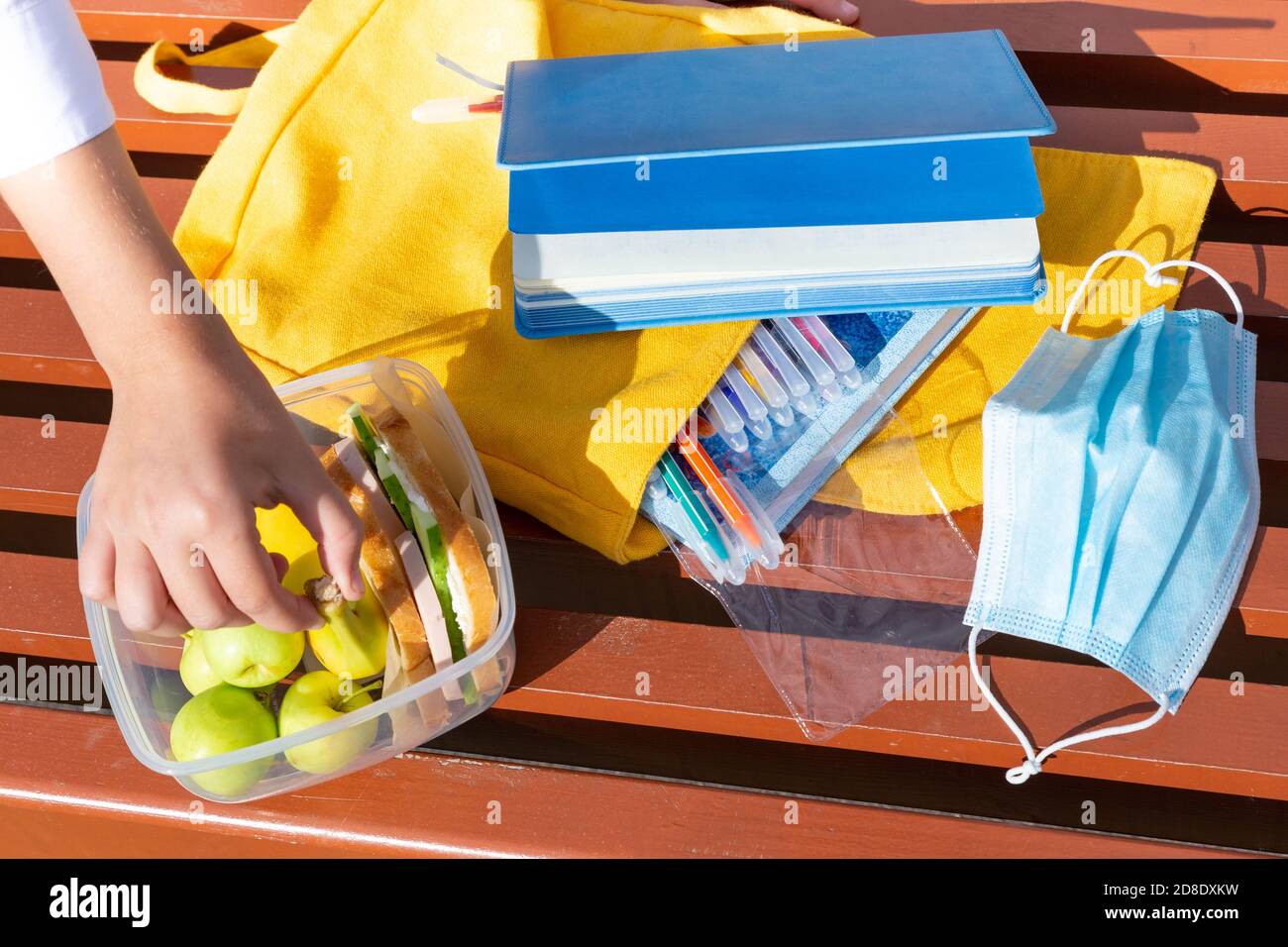Lunch box, child's hands. Sandwiches with bread, cucumber, sausage ...