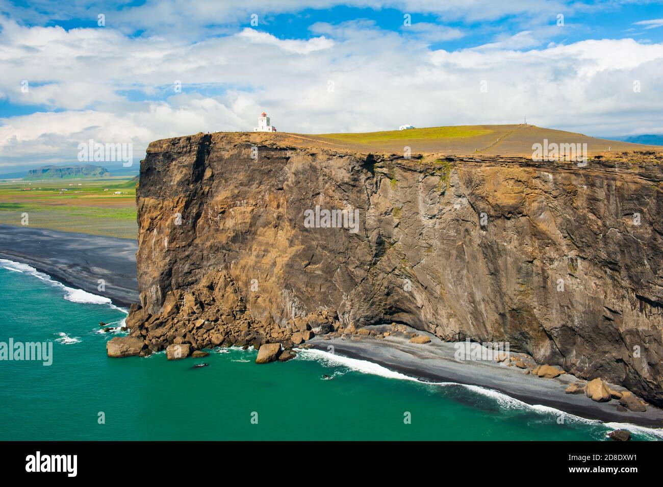 Small lighthouse on the cliff at the cape Dyrholaey, the most southern ...