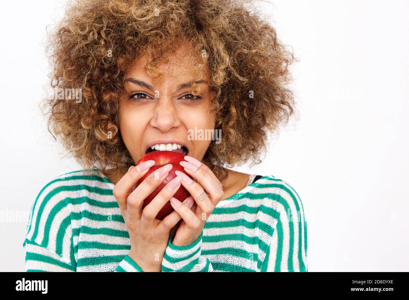 Portrait of healthy young african american woman biting an apple Stock ...