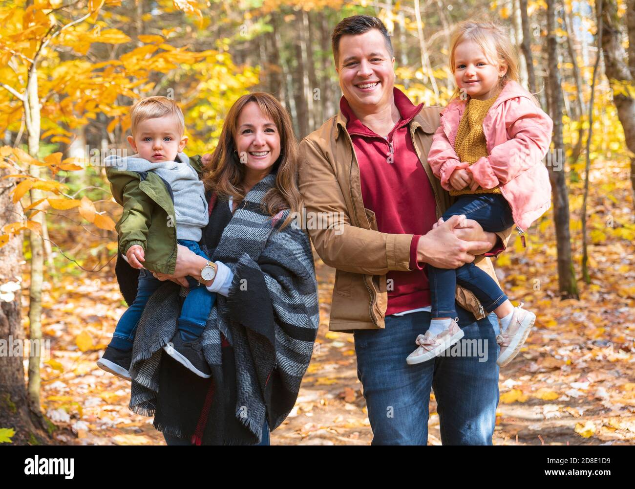 family having fun in the autumn forest Stock Photo - Alamy