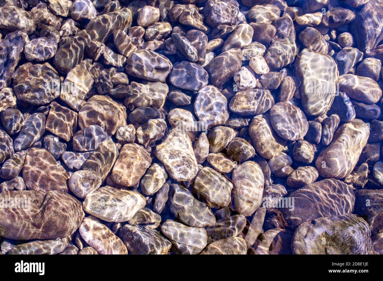 Background from pebble stone in water in sunlight. Wallpaper Stock ...