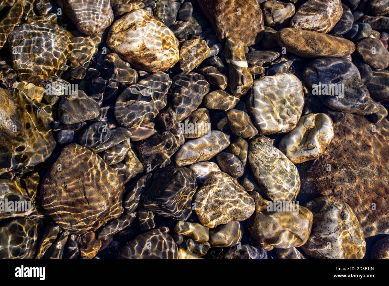 Background from pebble stone in water in sunlight. Wallpaper Stock ...