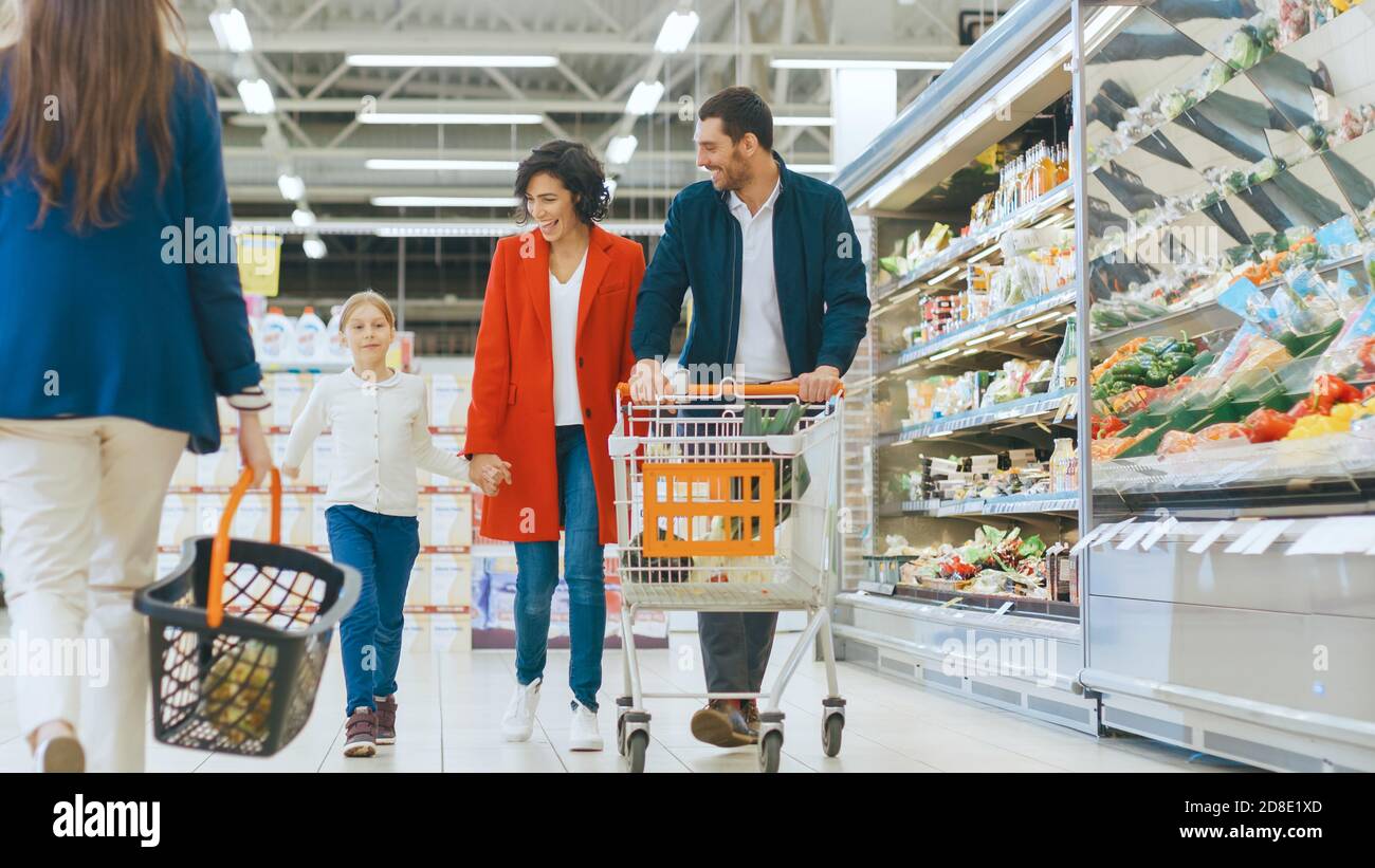 At the Supermarket: Happy Family of Three, Holding Hands, Walks Through ...