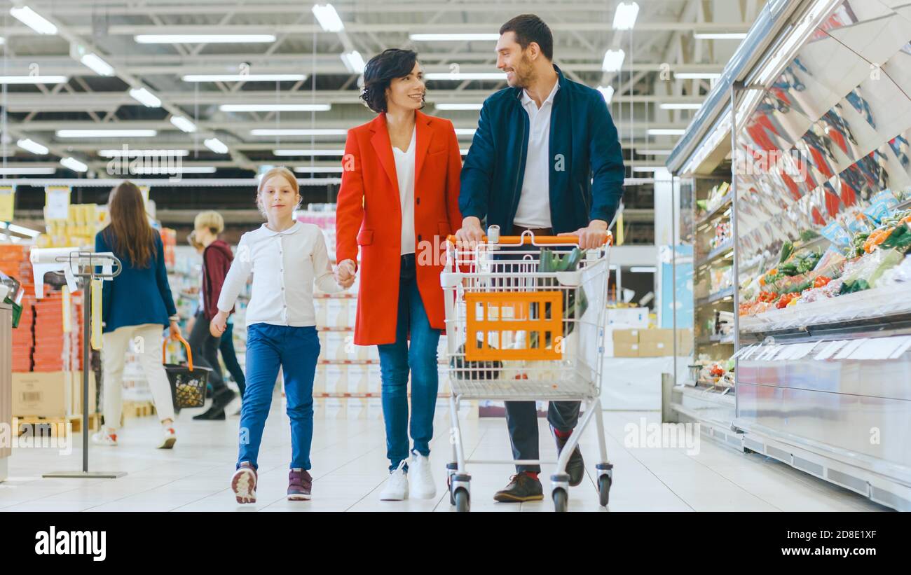 At the Supermarket: Happy Family of Three, Holding Hands, Walks Through ...
