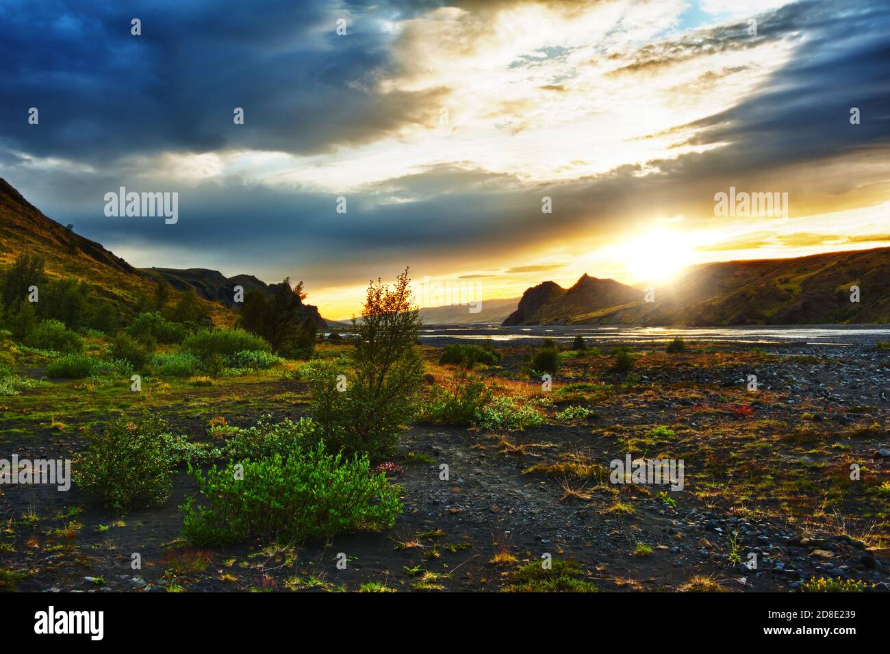 Midnight setting sun lits beautifully volcanic rocks and rivers at ...