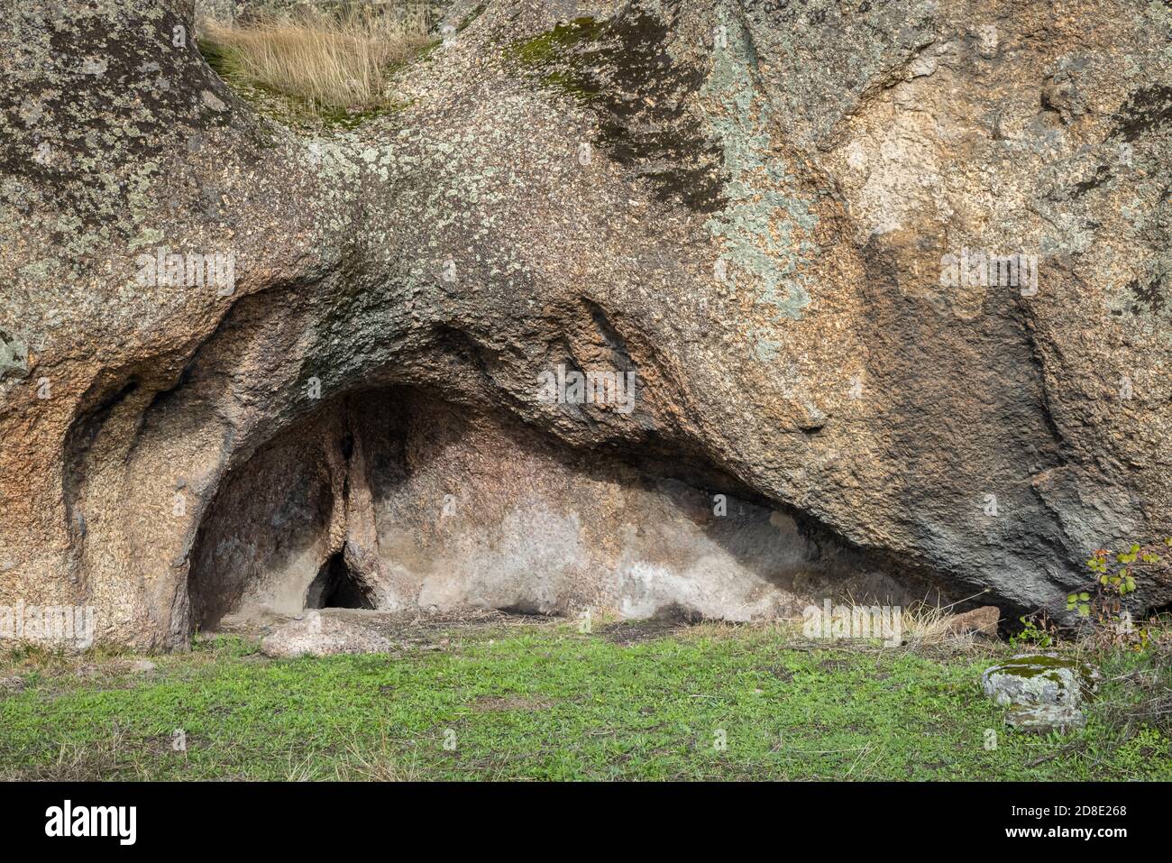 Small cave in a granite rock Stock Photo - Alamy